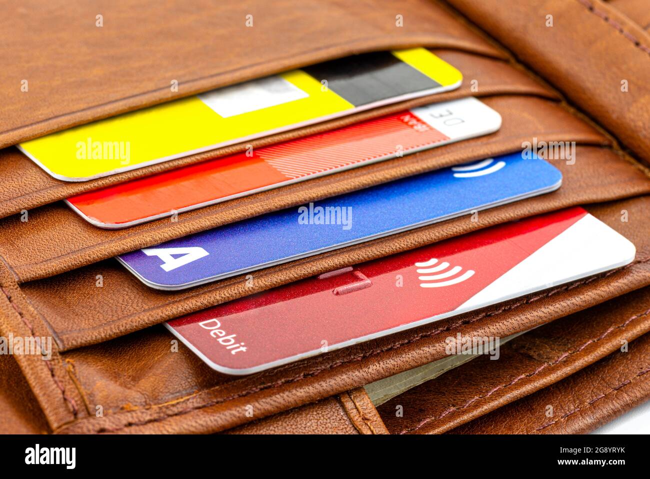 Macro photo of a brown mens leather wallet with debit and credit cards ...