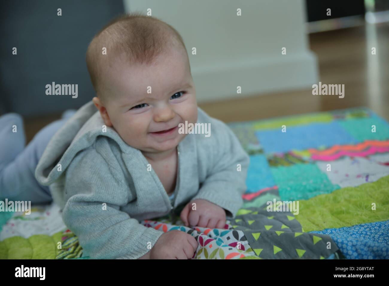 Shallow focus of an adorable Australian baby crawling on a mat on the ...