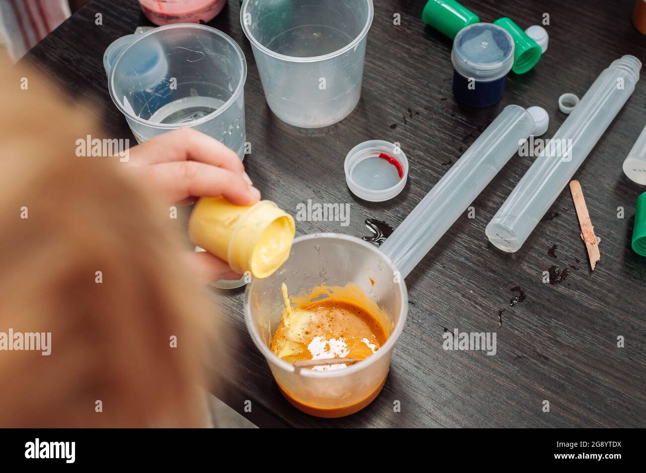 Person mixing colors for an art project Stock Photo - Alamy