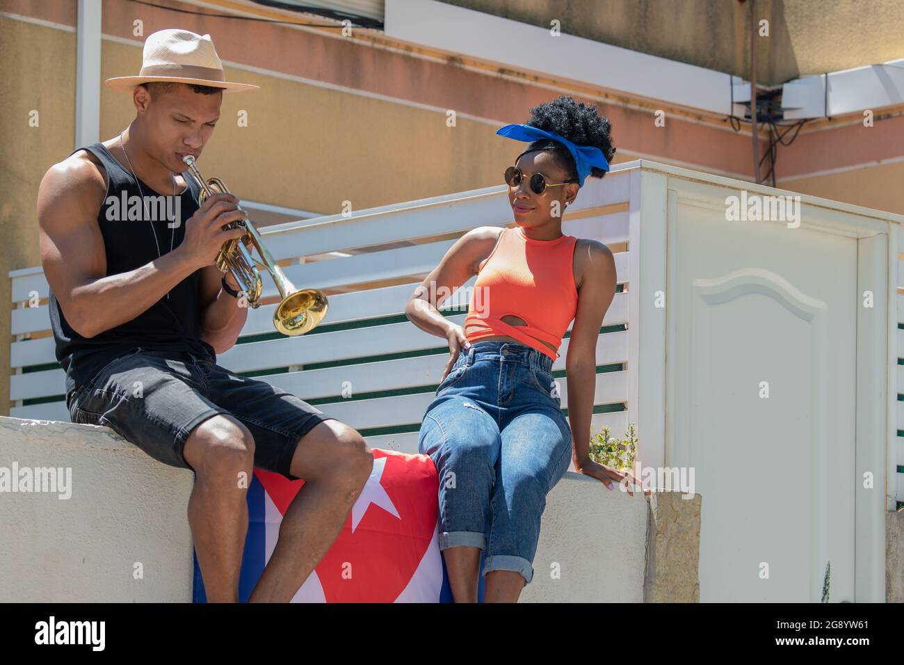 Latina woman watching a latino man playing a trumpet: Selective focus ...