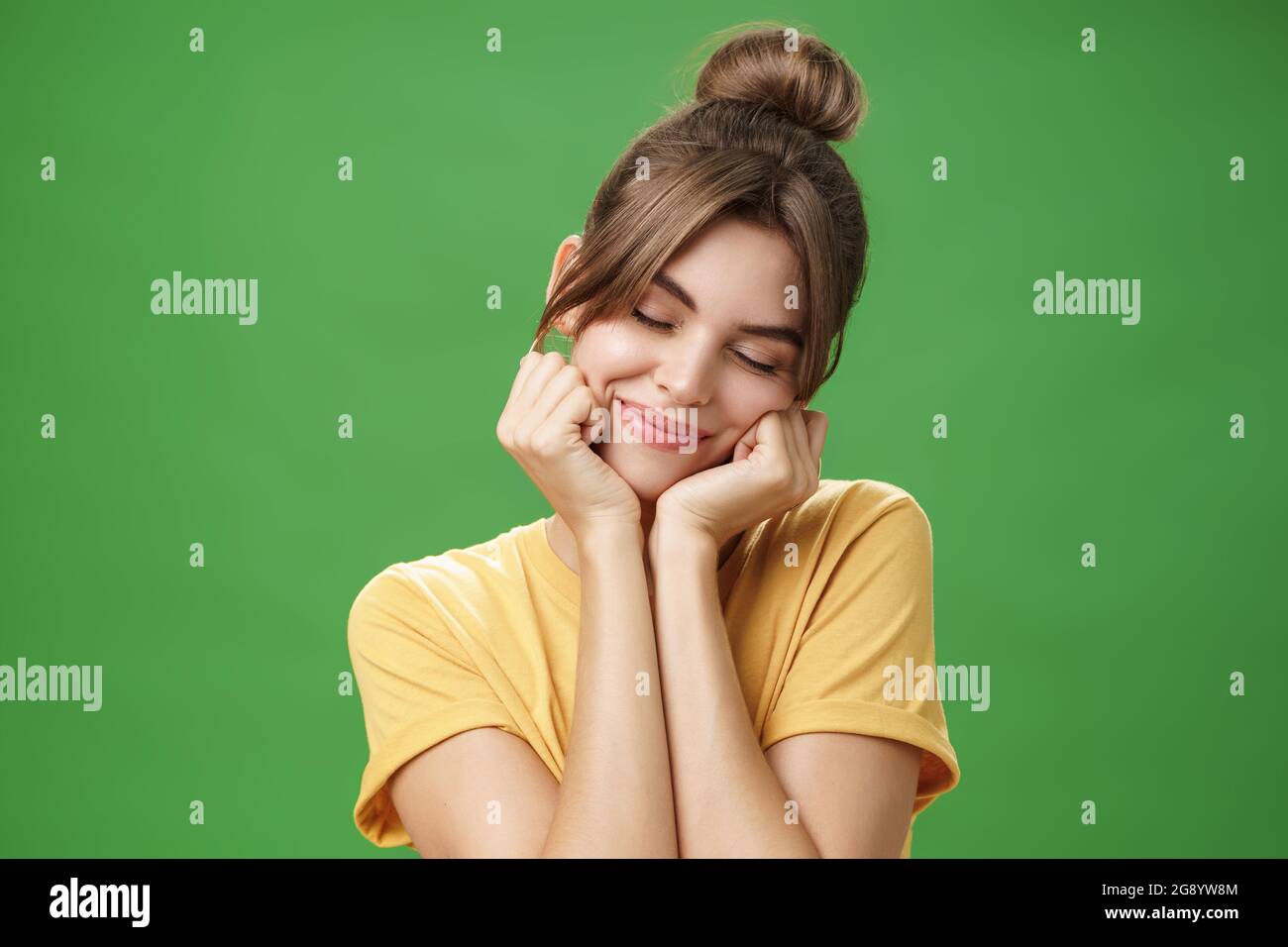 Tender sensual timid european girl in yellow t-shirt leaning head on ...