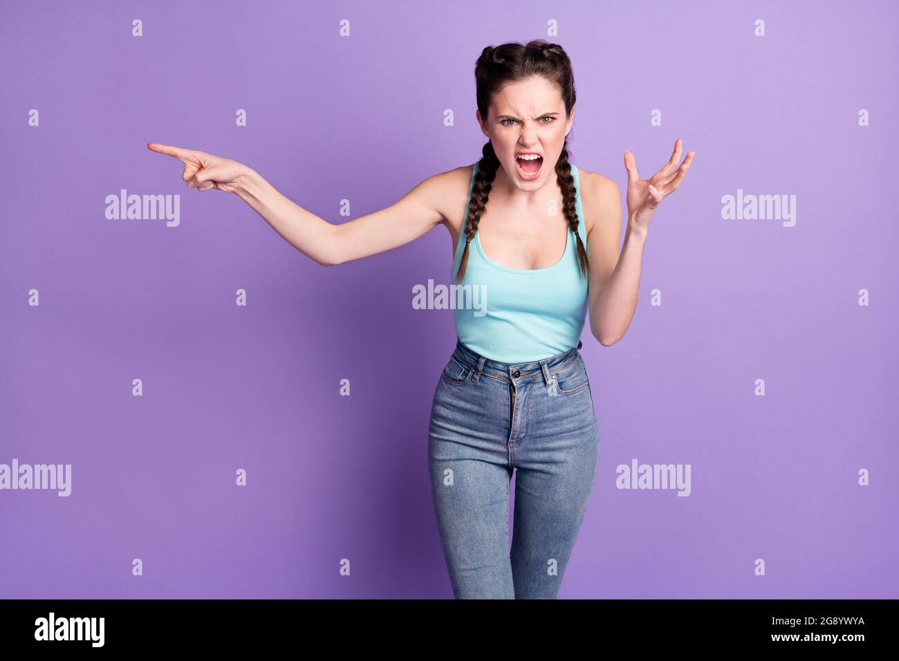 Portrait of mad furious crazy girl shouting loudly isolated over violet ...