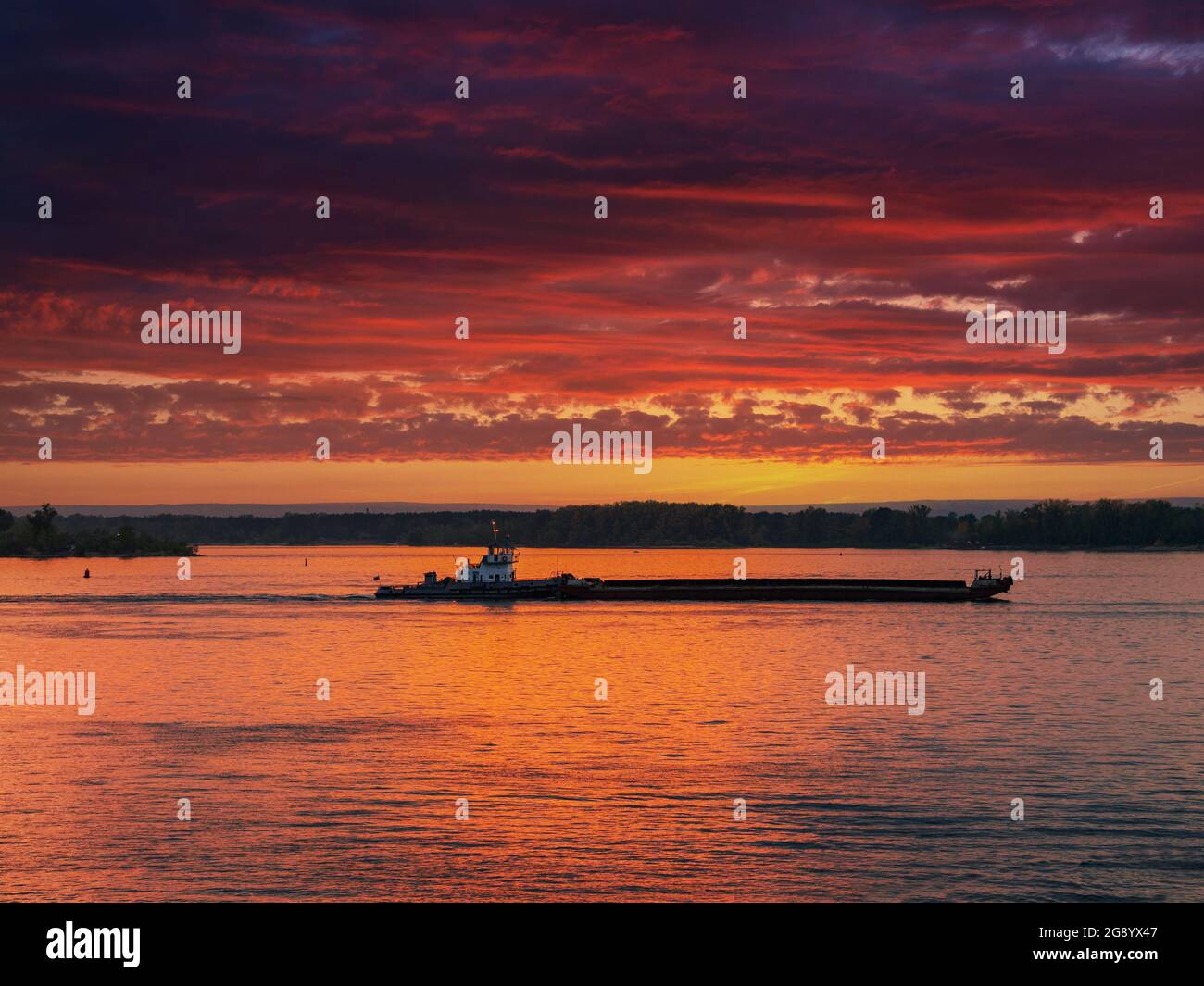 Self-propelled scow on the river with cargo on sunset river Stock Photo ...