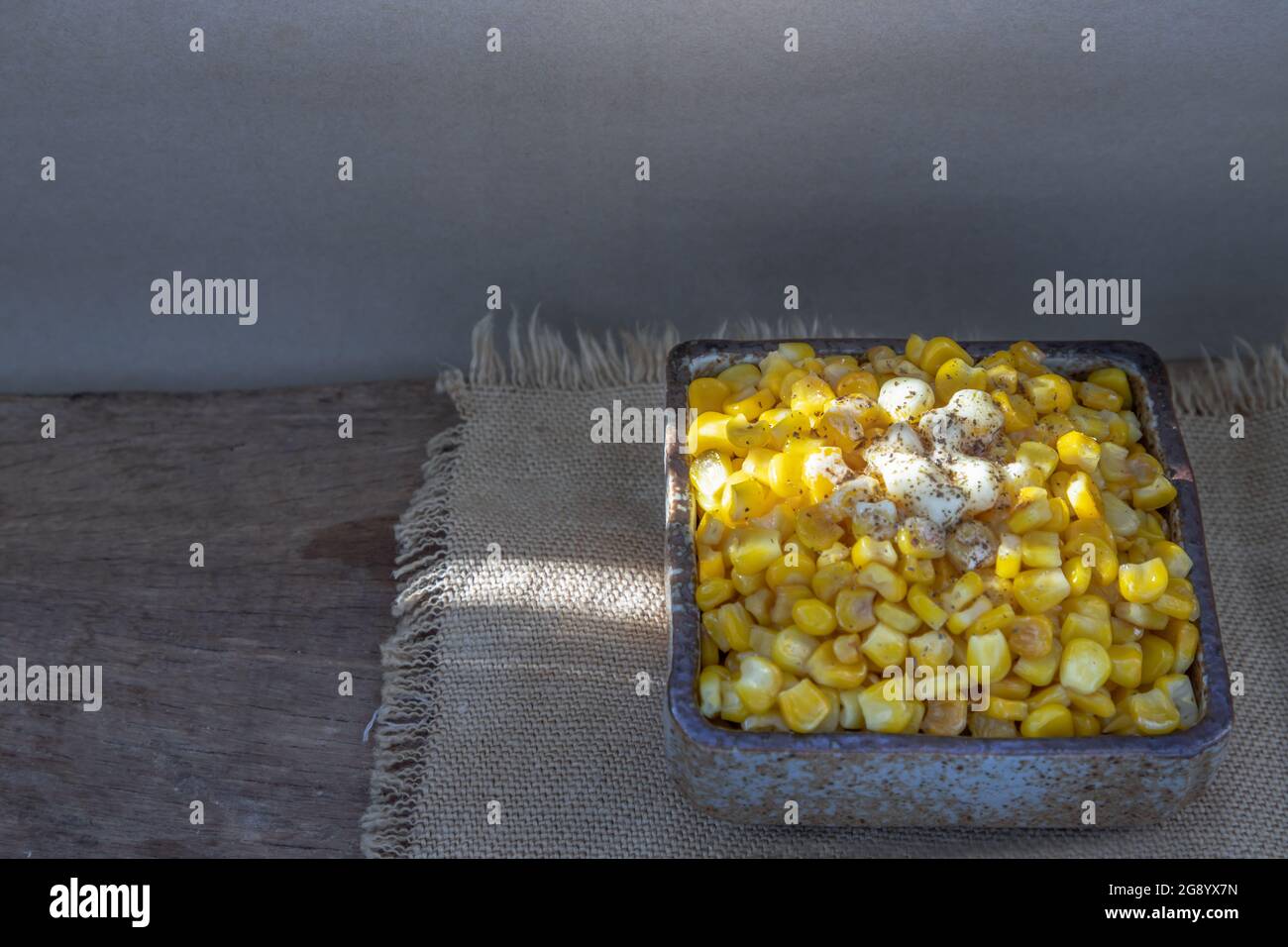 Fried sweet corn with a knob of butter and seasonings Sprinkle with ...