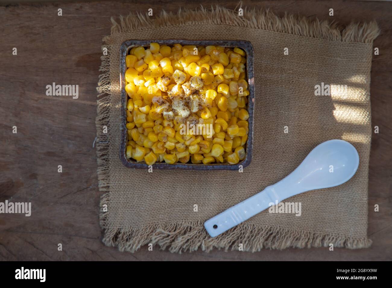 Fried sweet corn with a knob of butter and seasonings Sprinkle with ...