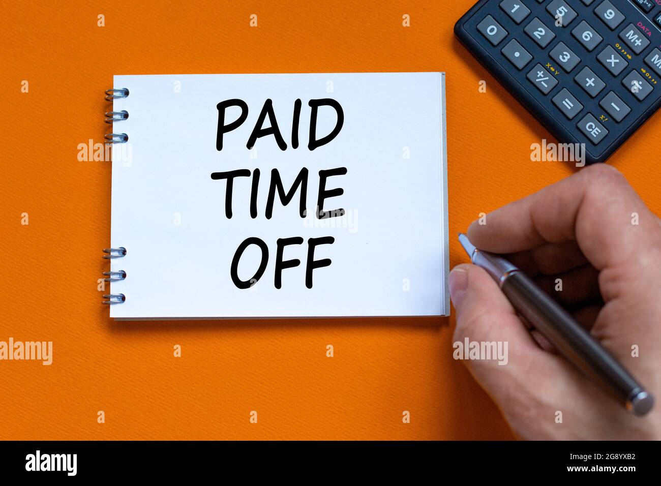 Paid time off symbol. Businessman writing words 'Paid time off' on ...
