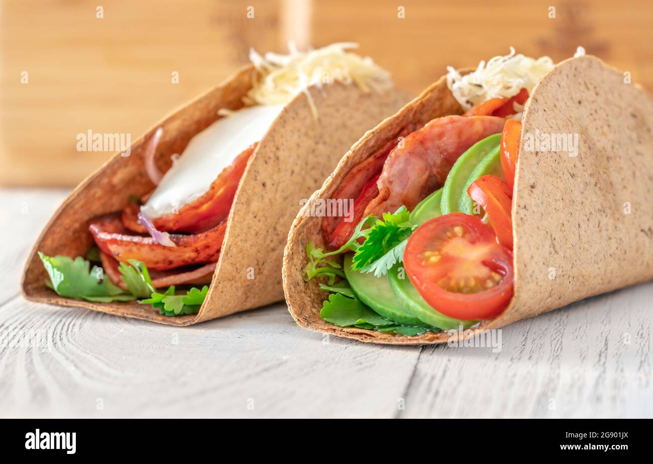 Tacos with ham and vegetables on the serving wooden plate Stock Photo ...