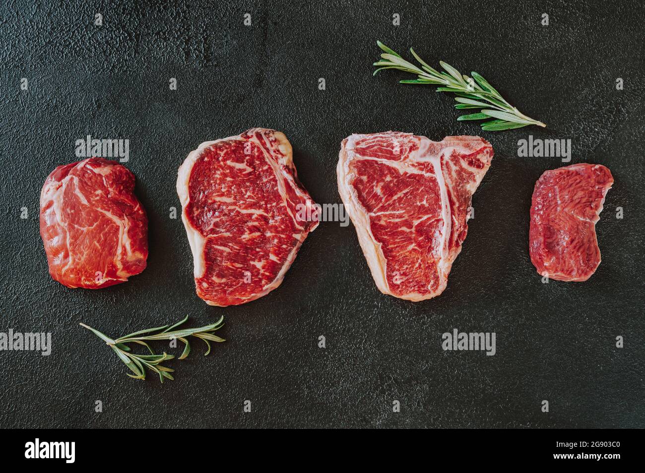 Variety of beef steaks on dark background Stock Photo - Alamy