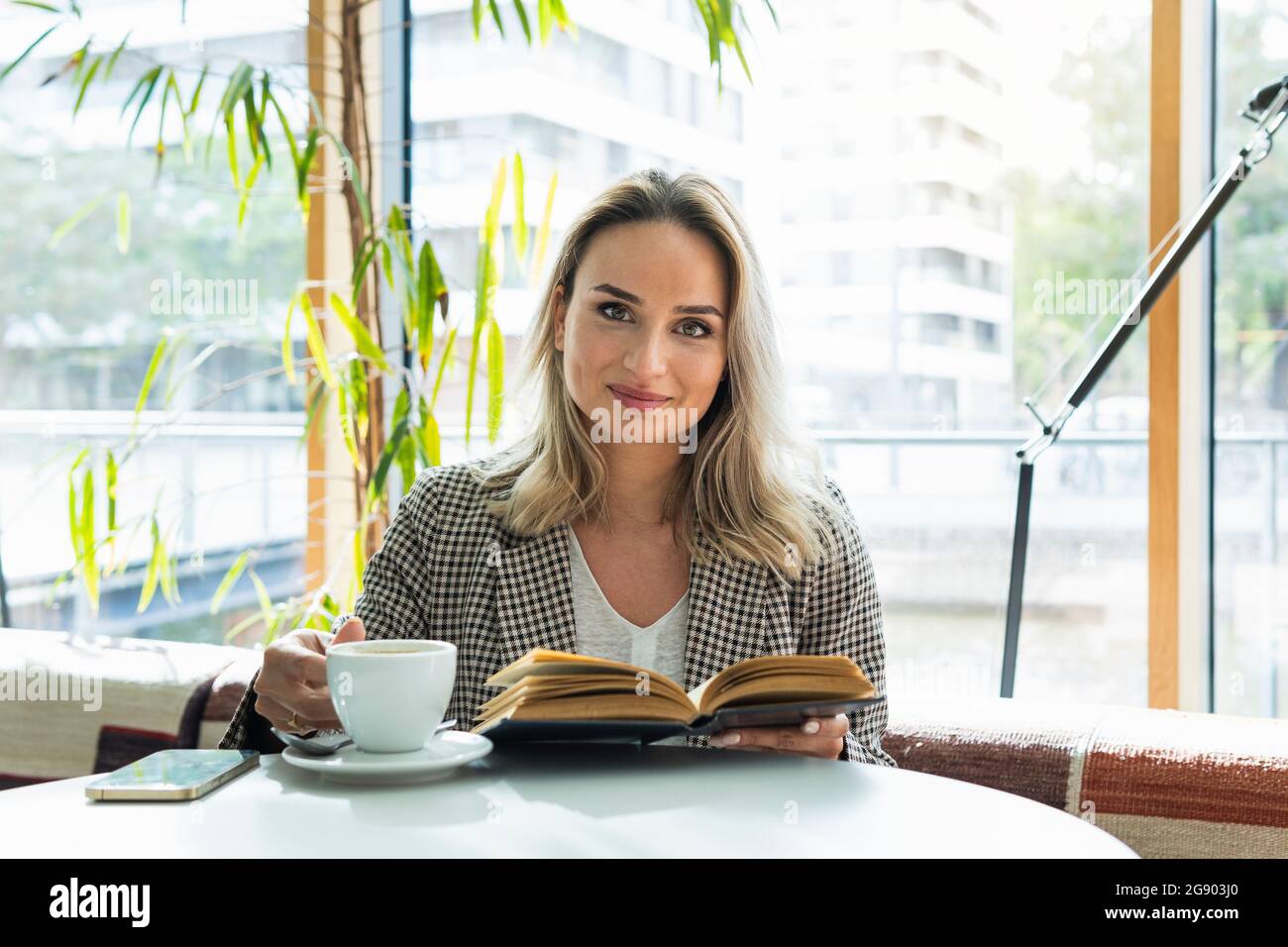 Female freelance worker having coffee at cafe Stock Photo - Alamy