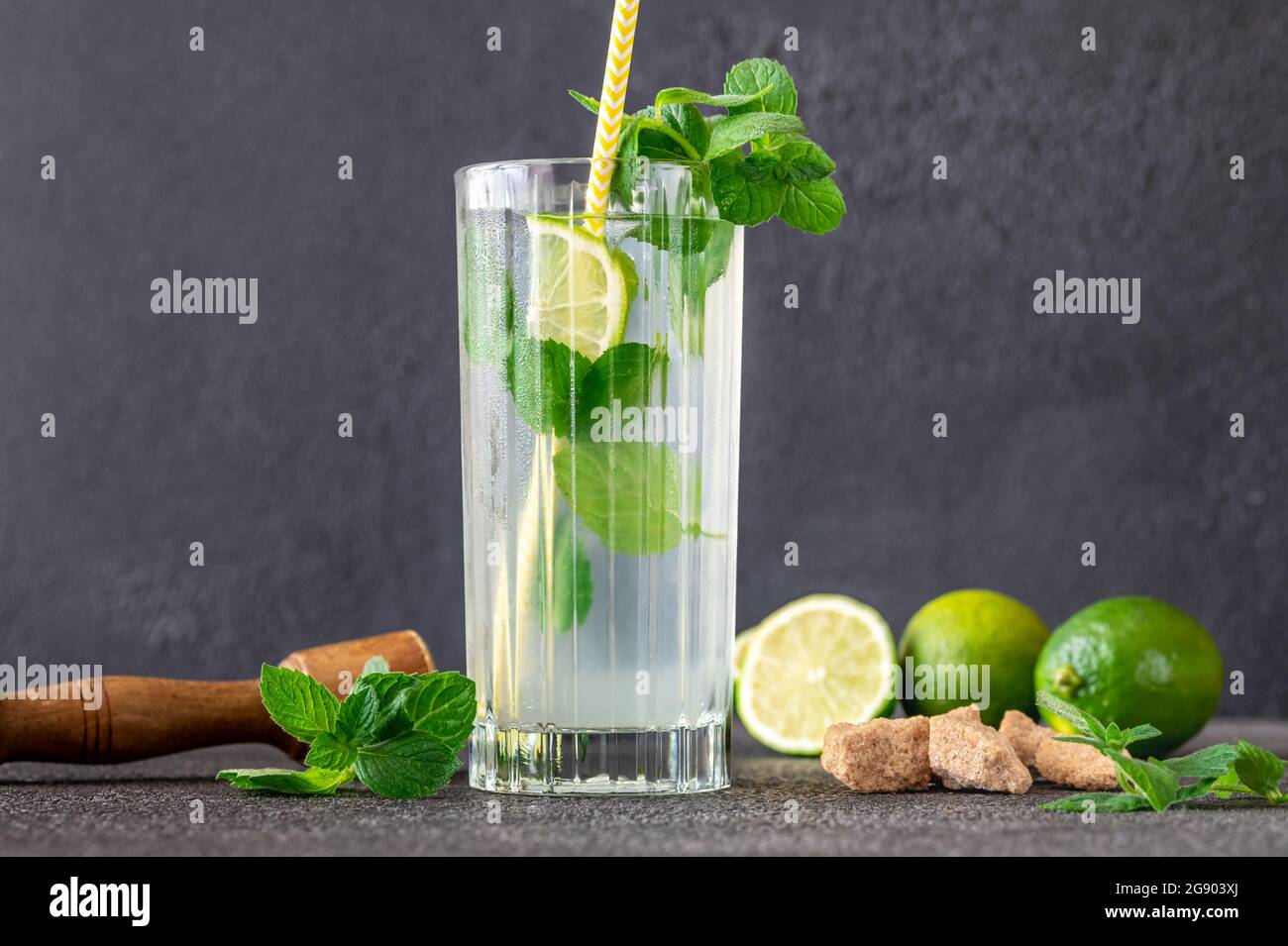 Glass of mojito cocktail with ingredients on dark background Stock ...