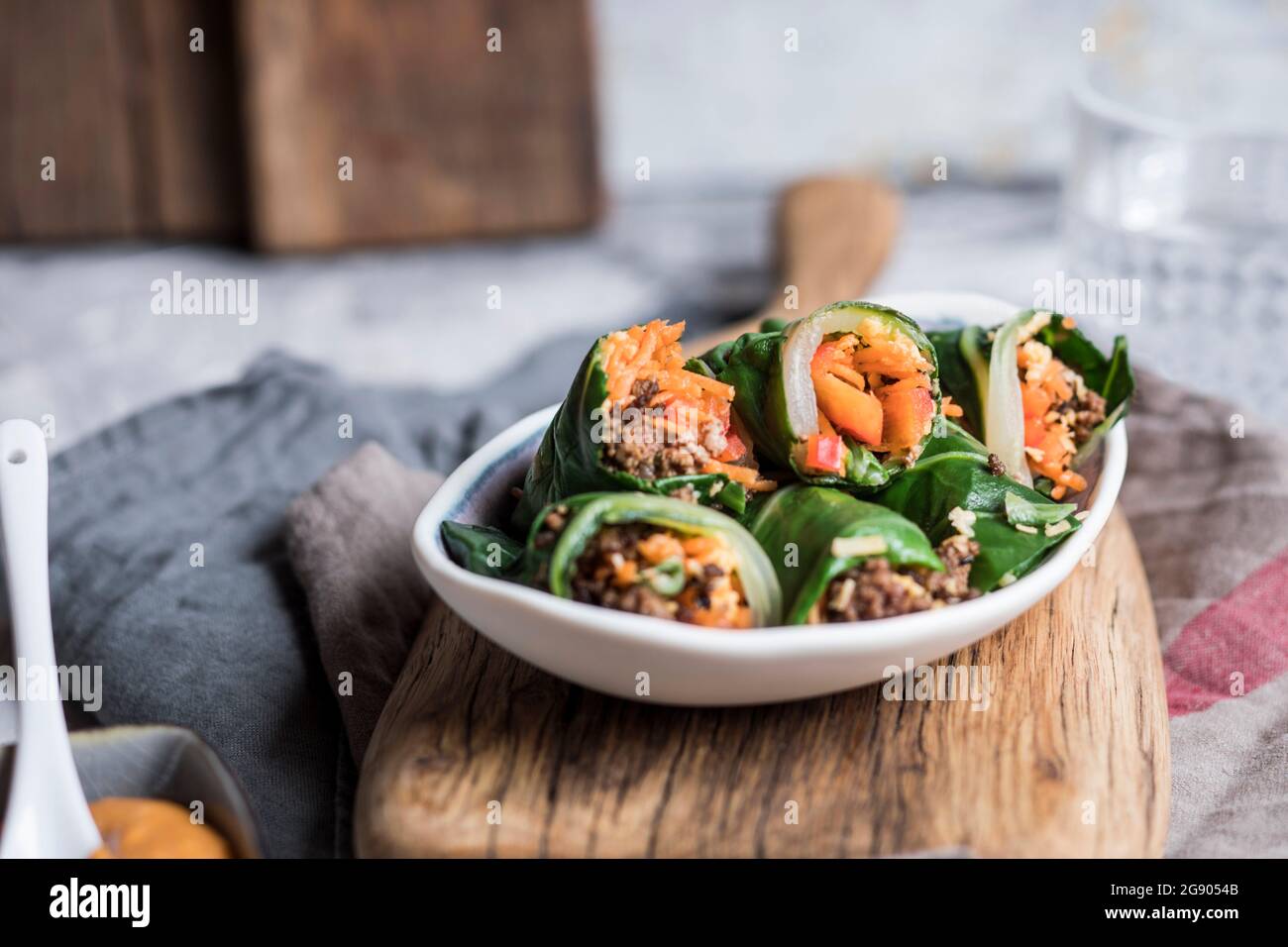 Steamed spring rolls with chopped vegetable and meat filling in tray ...