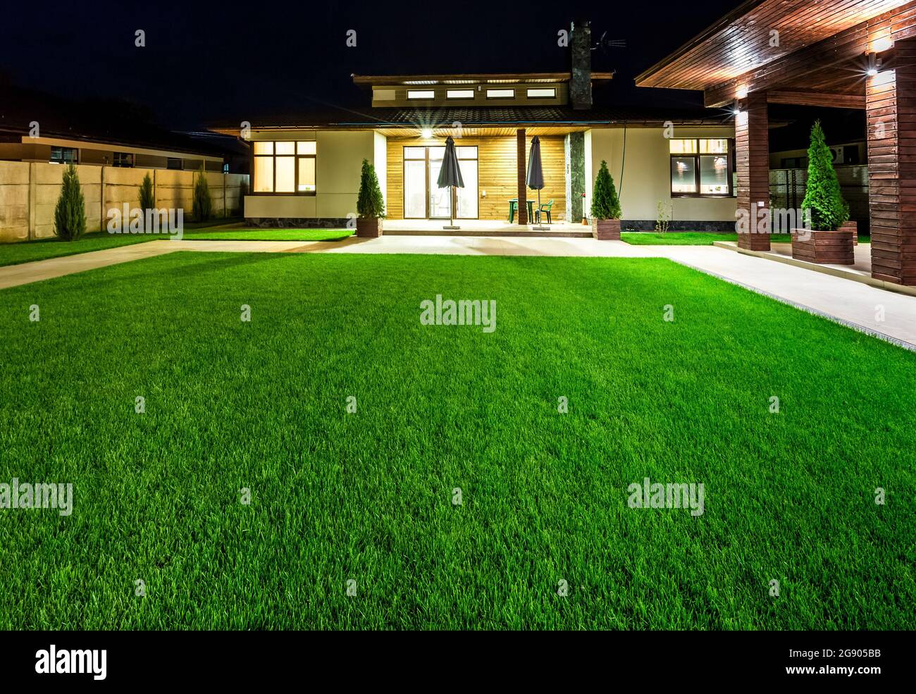 Detached house at night view from outside the rear courtyard Stock ...