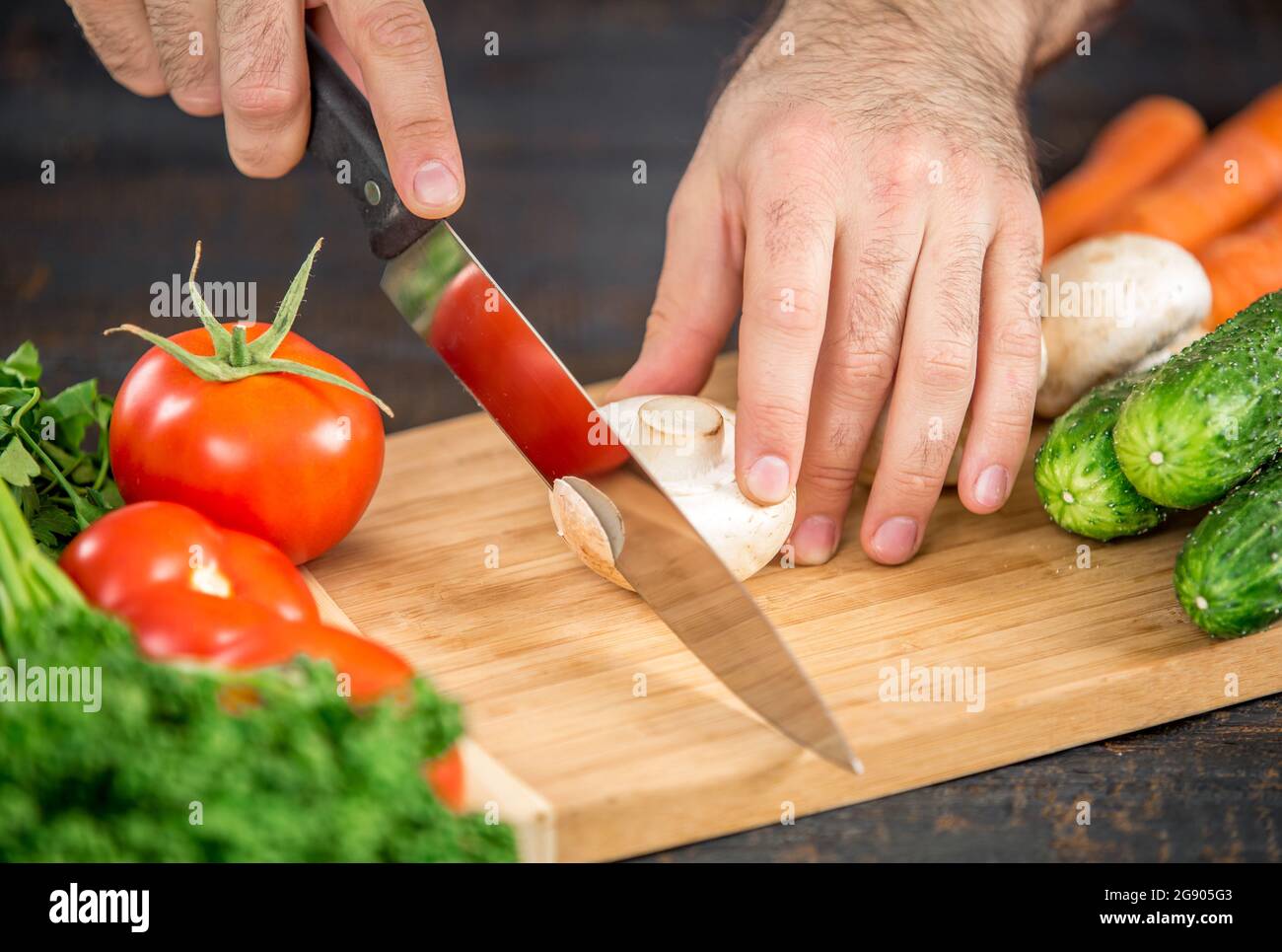 Male hands cutting vegetables for salad Stock Photo - Alamy