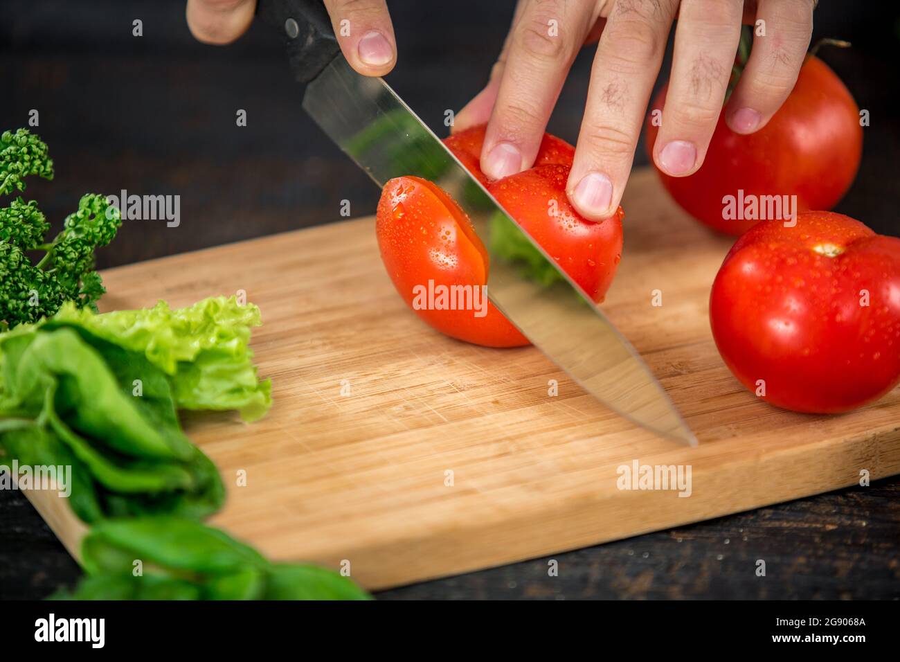 Male hands cutting tomato slicing hi-res stock photography and images ...