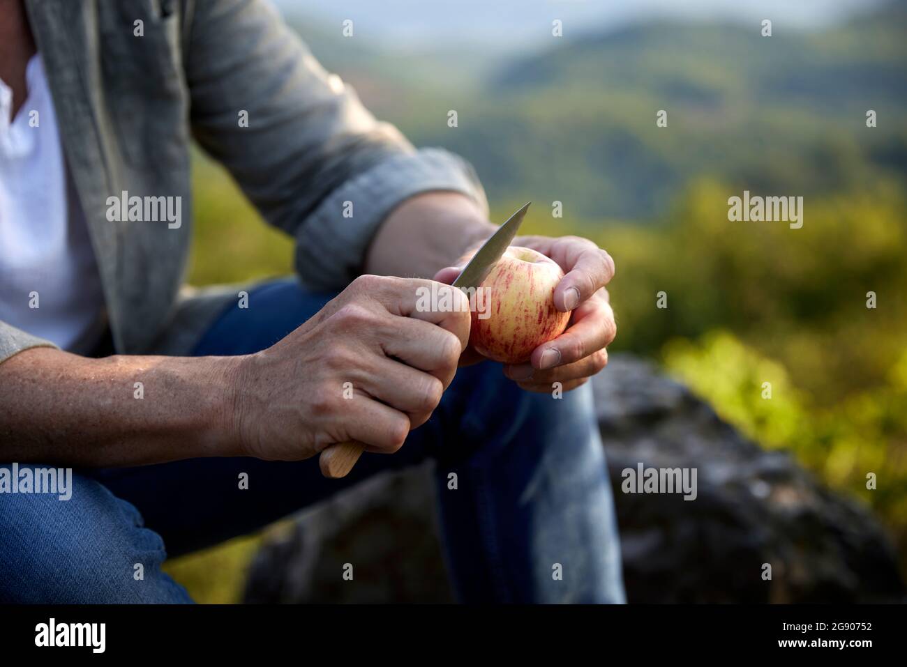 Man cutting apple with knife Stock Photo - Alamy