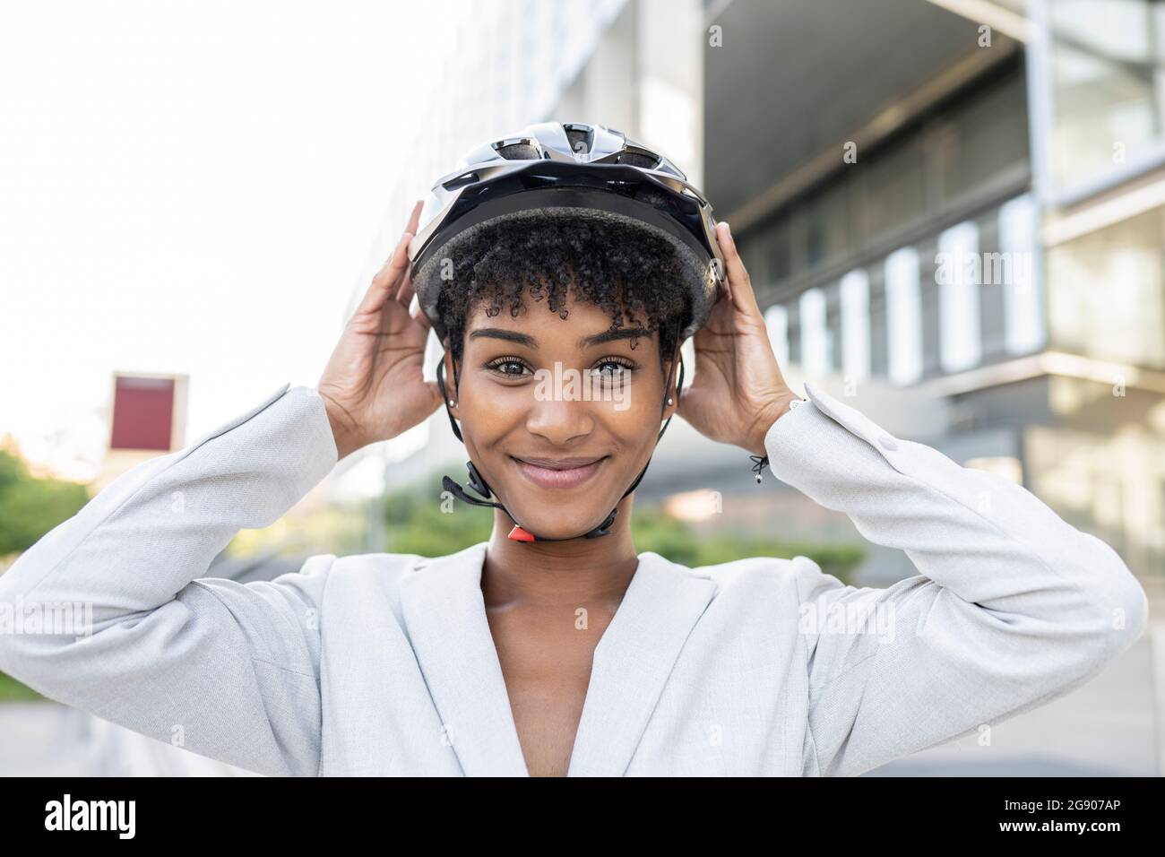 Young woman adjusting helmet hi-res stock photography and images - Alamy