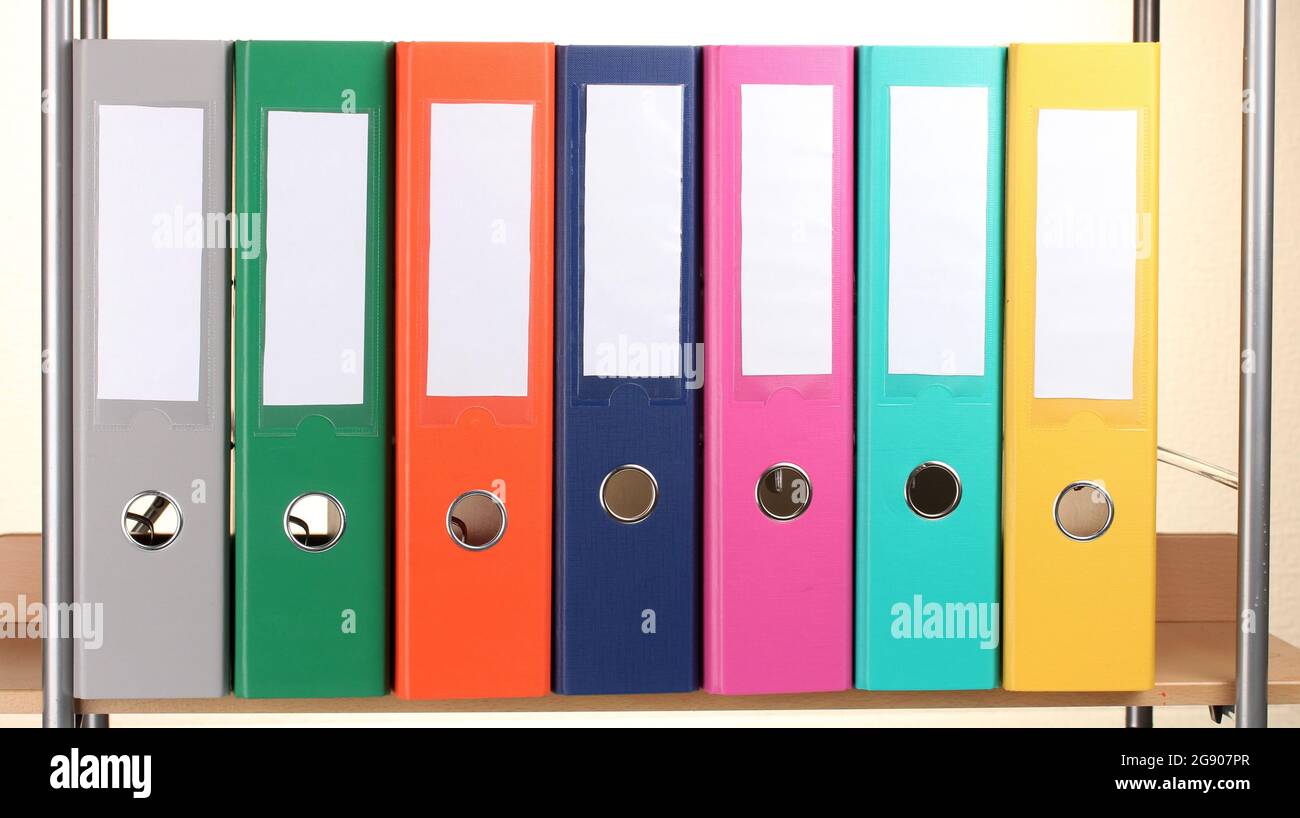 bright office folders on wooden shelf Stock Photo - Alamy
