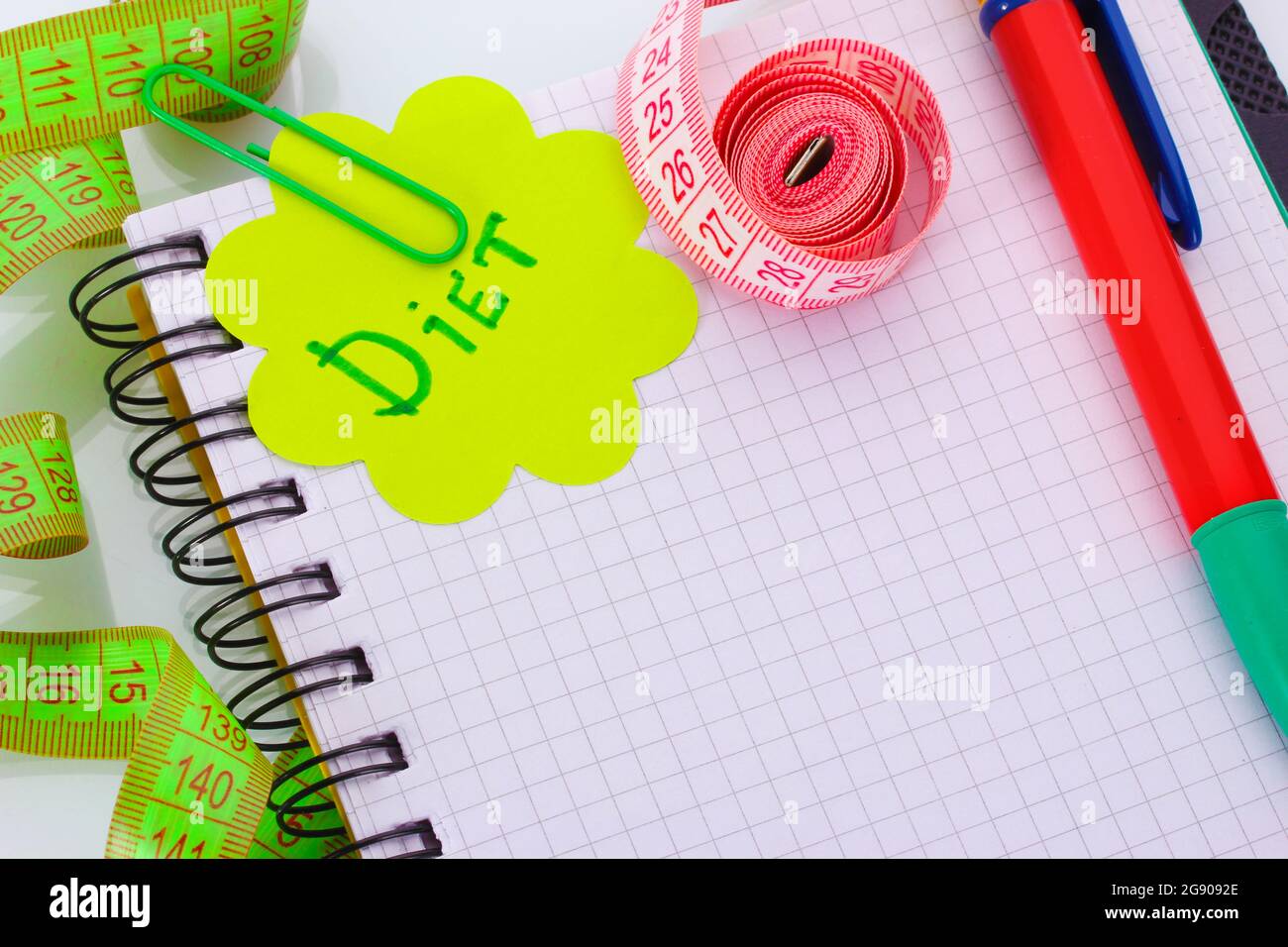 Planning of diet. Notebook measuring tapes and pen isolated on white ...