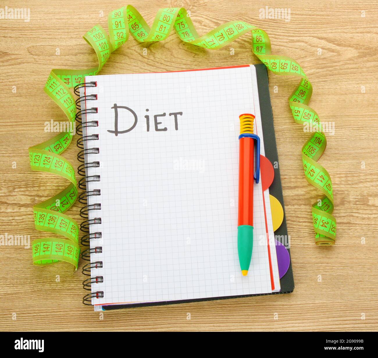 Planning of diet. Notebook measuring tape and pen on wooden table Stock ...
