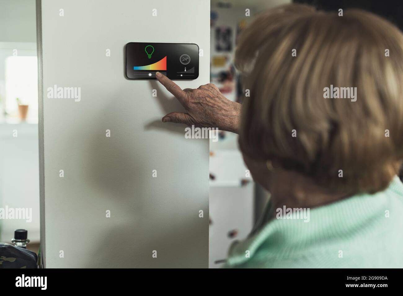 Woman adjusting temperature graph on home automation device Stock Photo ...