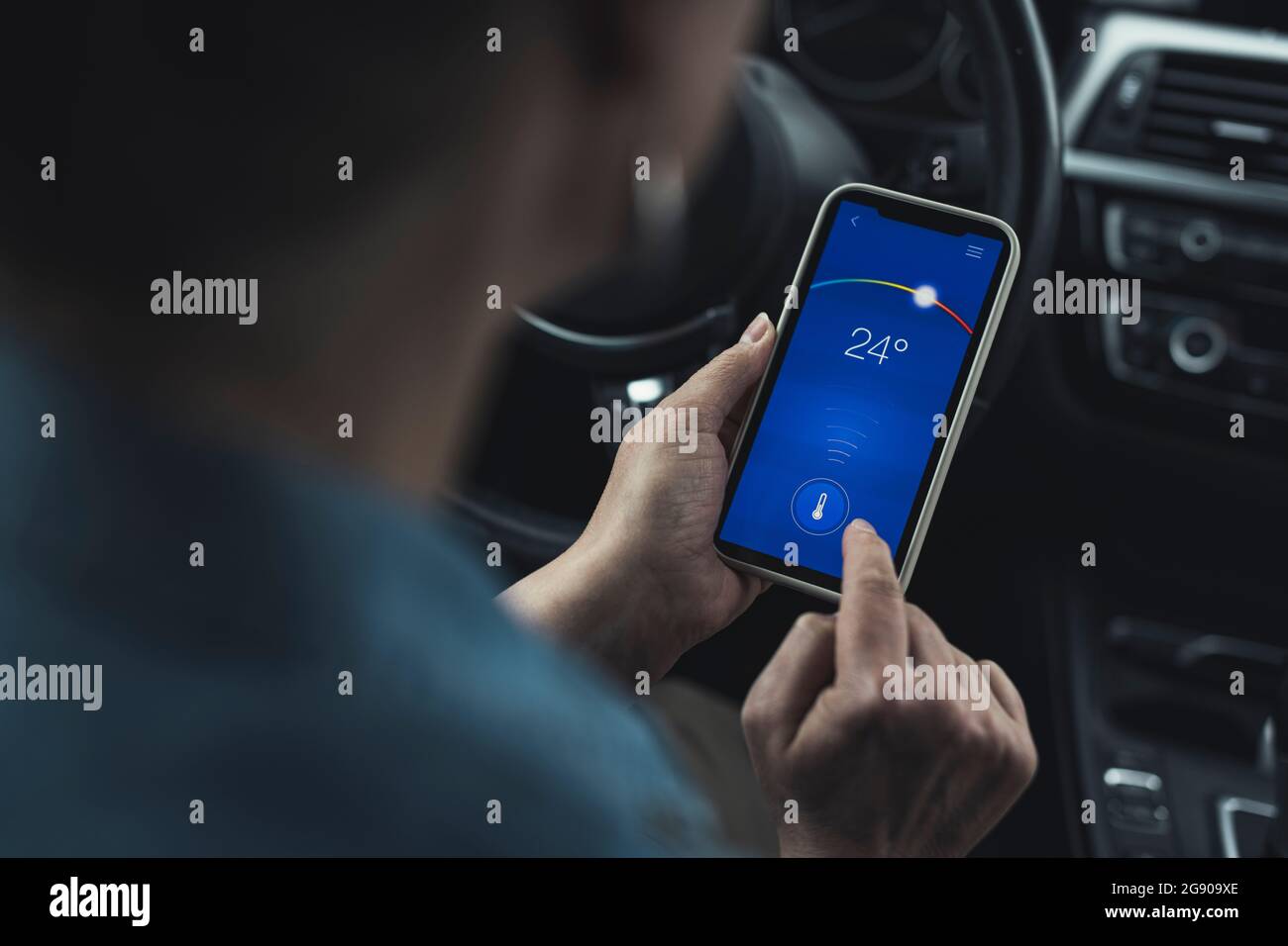 Woman operating temperature through smart phone in car Stock Photo - Alamy