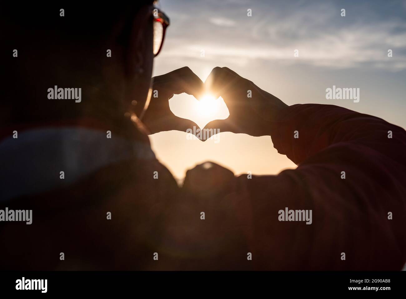 Heart and hands and sunset hi-res stock photography and images - Alamy