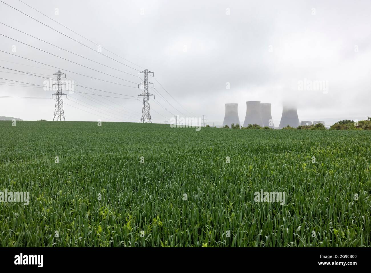 Field electricity pylons and cooling towers background hi-res stock ...