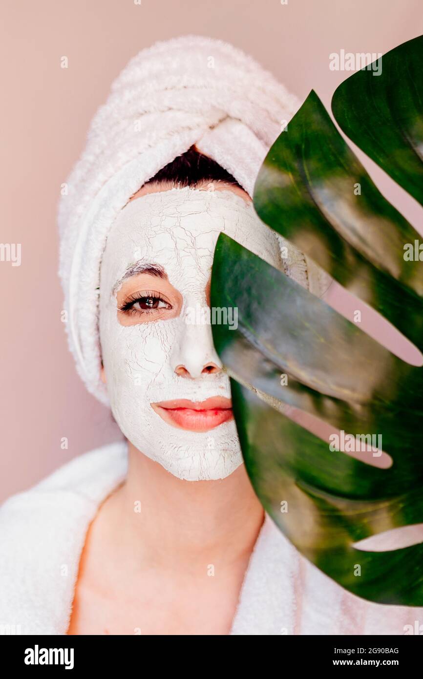 Young woman covering eye leaf hi-res stock photography and images - Alamy