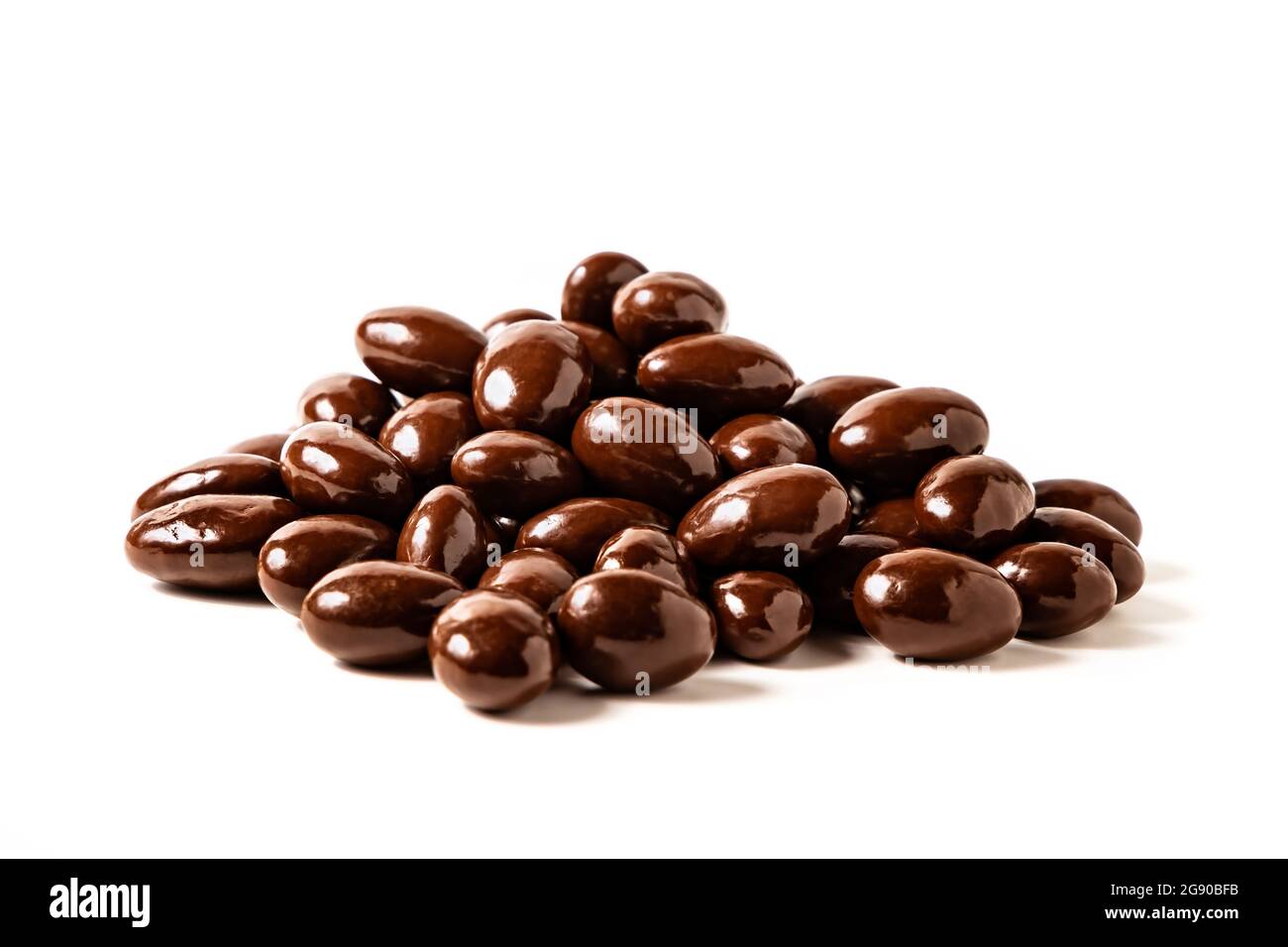 Dark chocolate covered almonds, isolated Stock Photo - Alamy