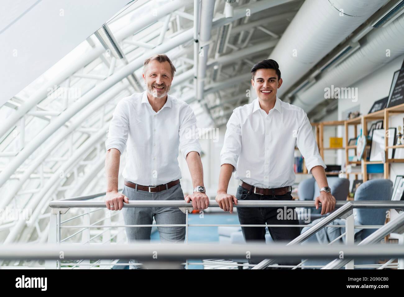 Two colleagues leaning on railing hi-res stock photography and images ...