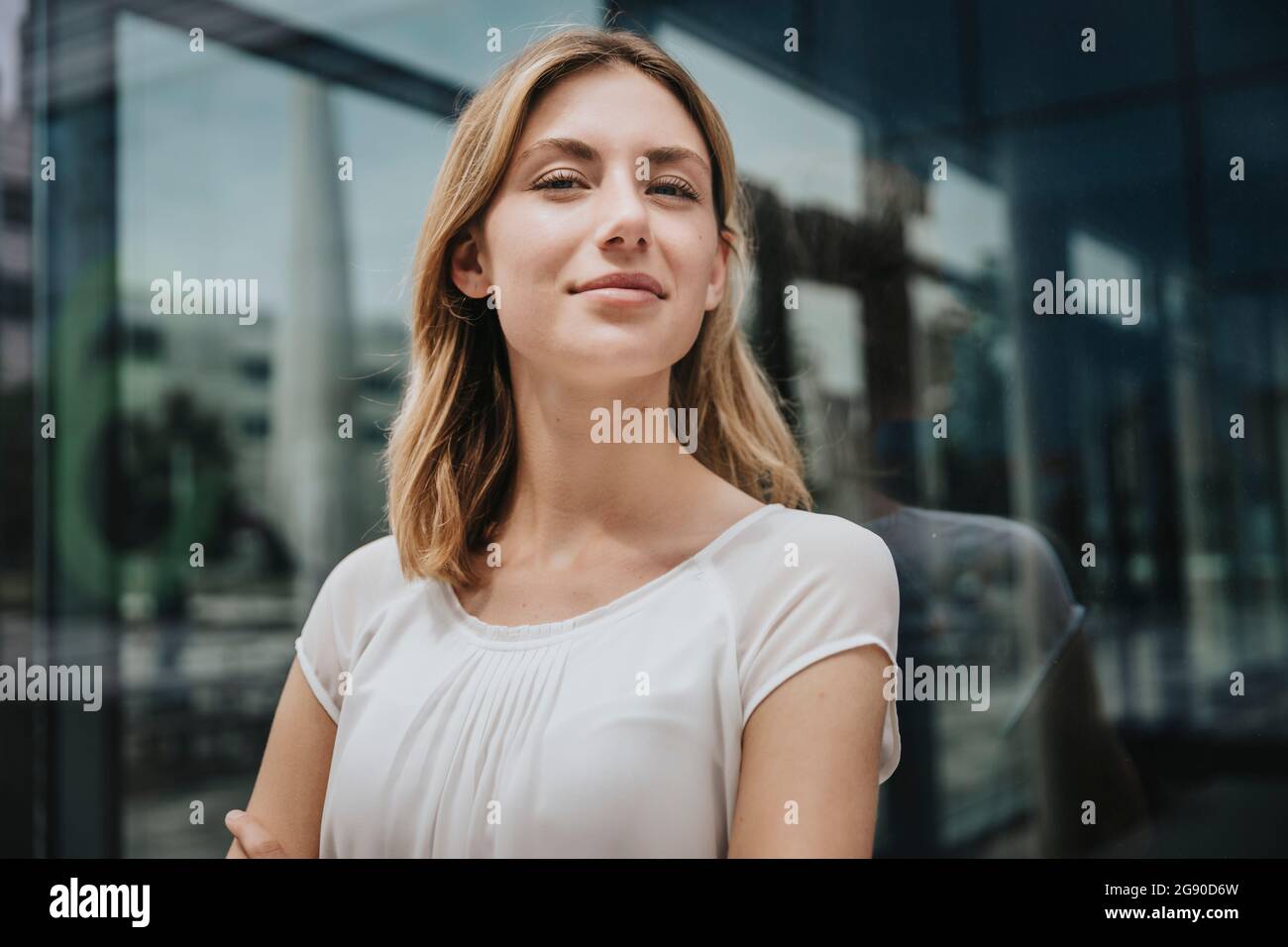 Beautiful woman in front of glass wall Stock Photo - Alamy