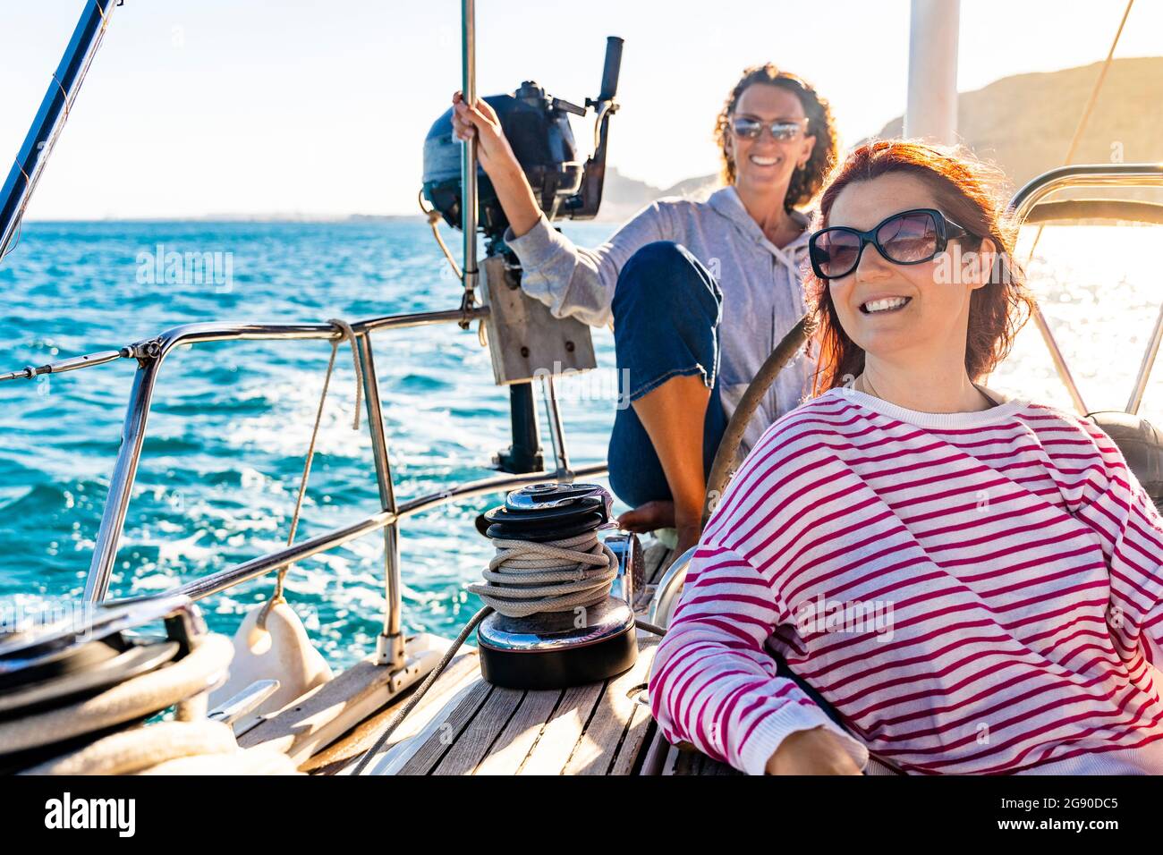 Female friends enjoying sunny day on sailing ship Stock Photo - Alamy