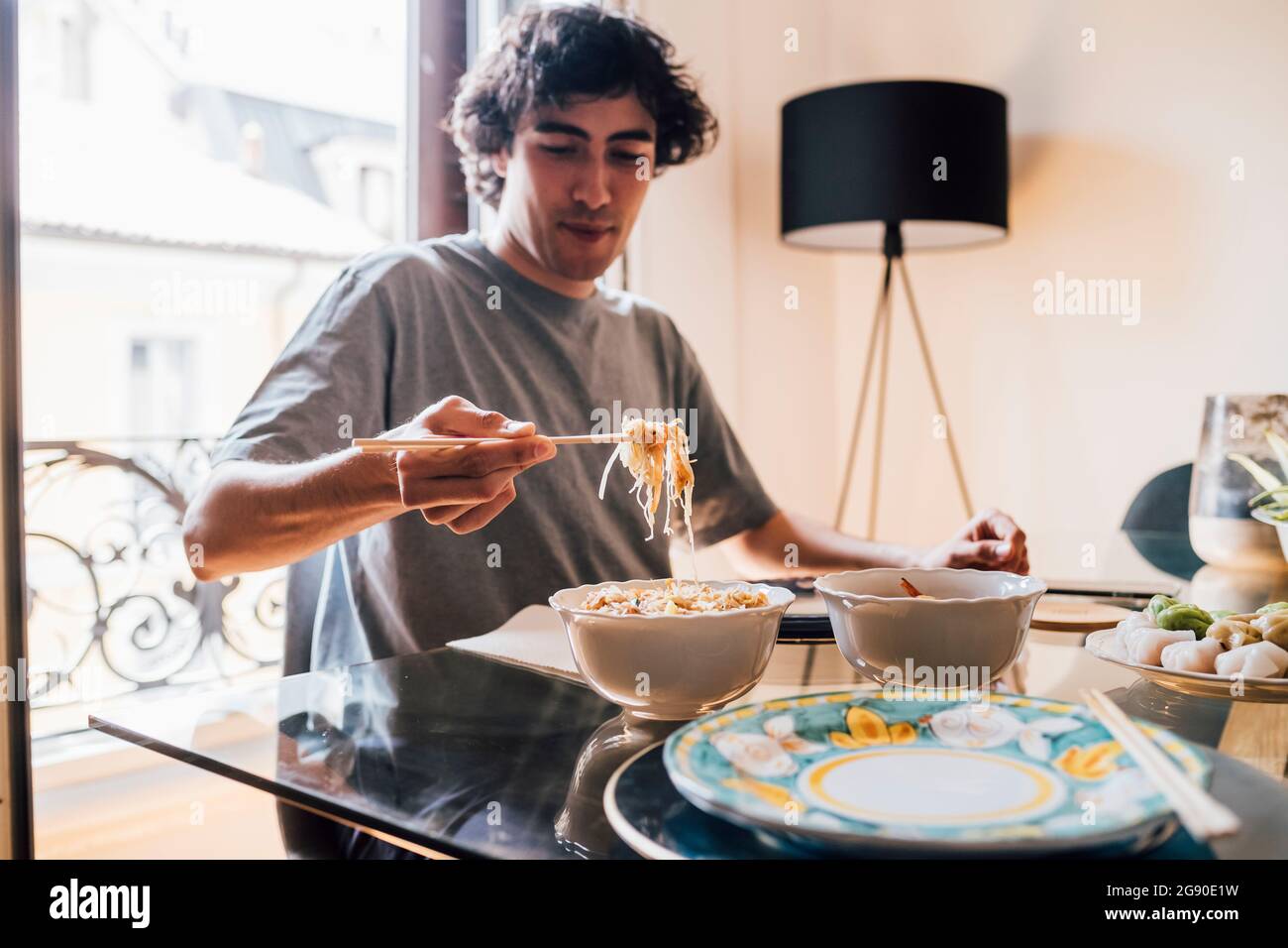 Woman taking food from plate hi-res stock photography and images - Alamy