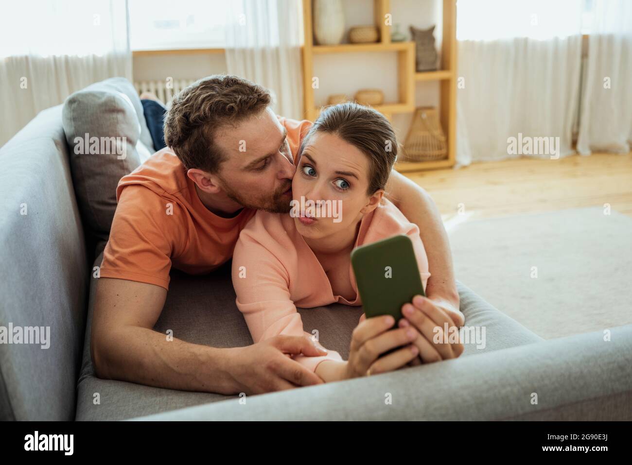 Woman man kissing sofa hi-res stock photography and images - Alamy