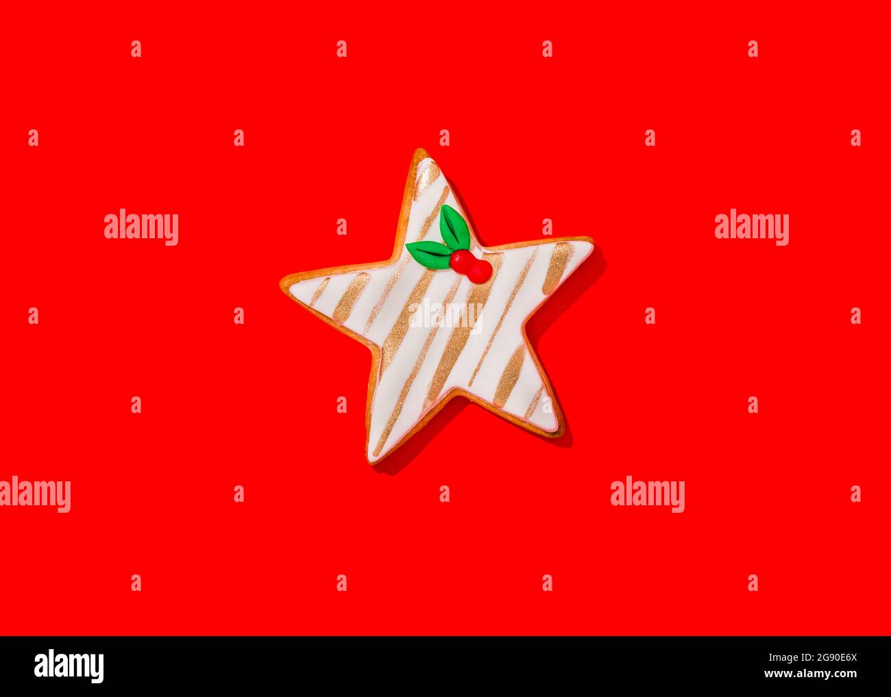 Star shaped Christmas cookie against vibrant red background Stock Photo ...