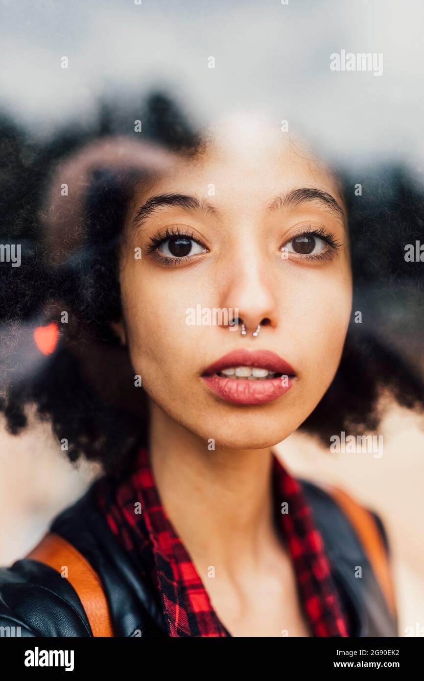 Young woman with nose ring seen through glass Stock Photo - Alamy