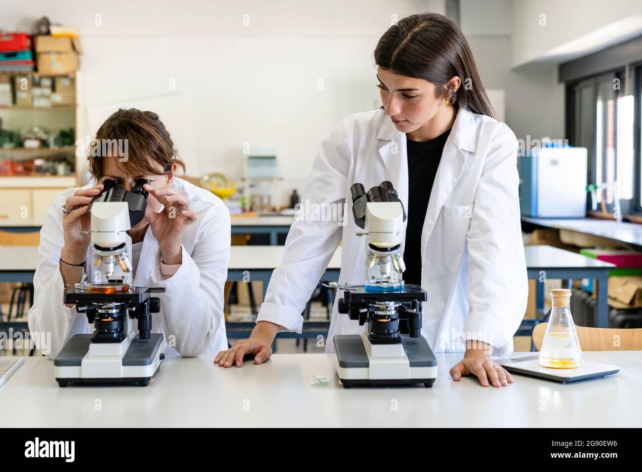 Female scientist looking through microscope hi-res stock photography ...