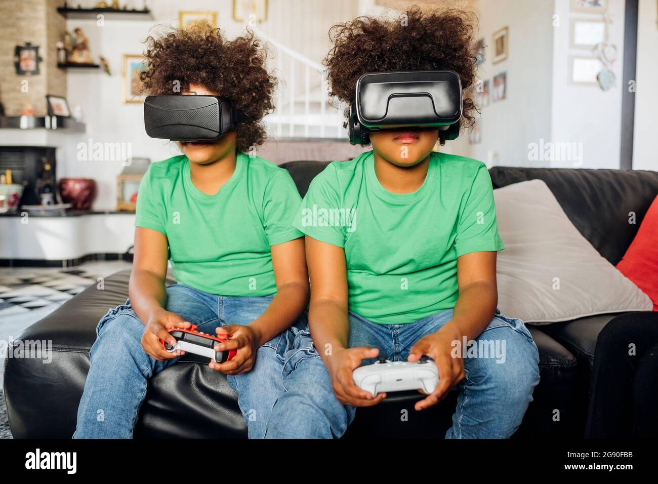 Twin brothers playing game wearing Virtual reality glasses at home ...