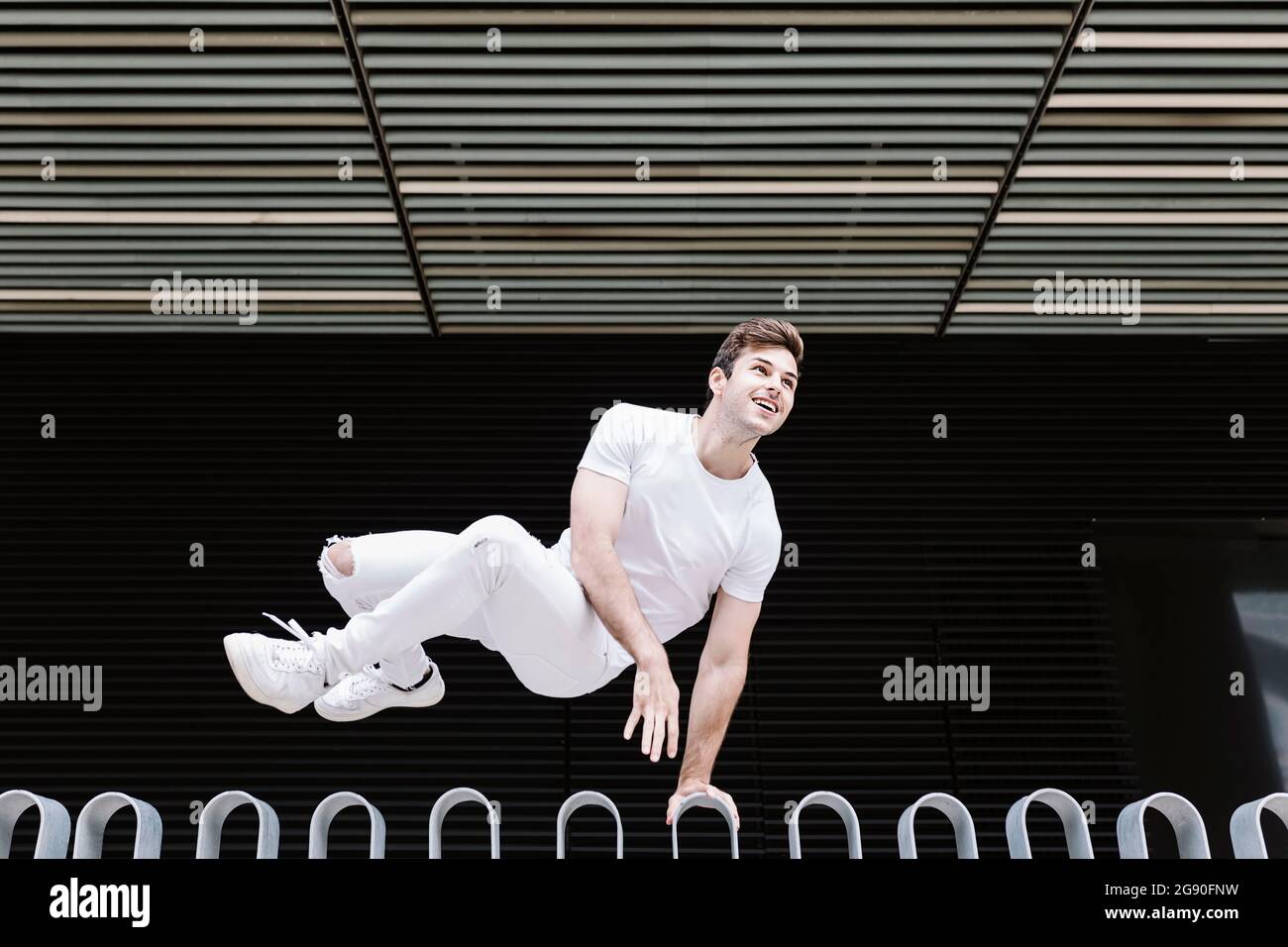 Young man jumping over railing hi-res stock photography and images - Alamy