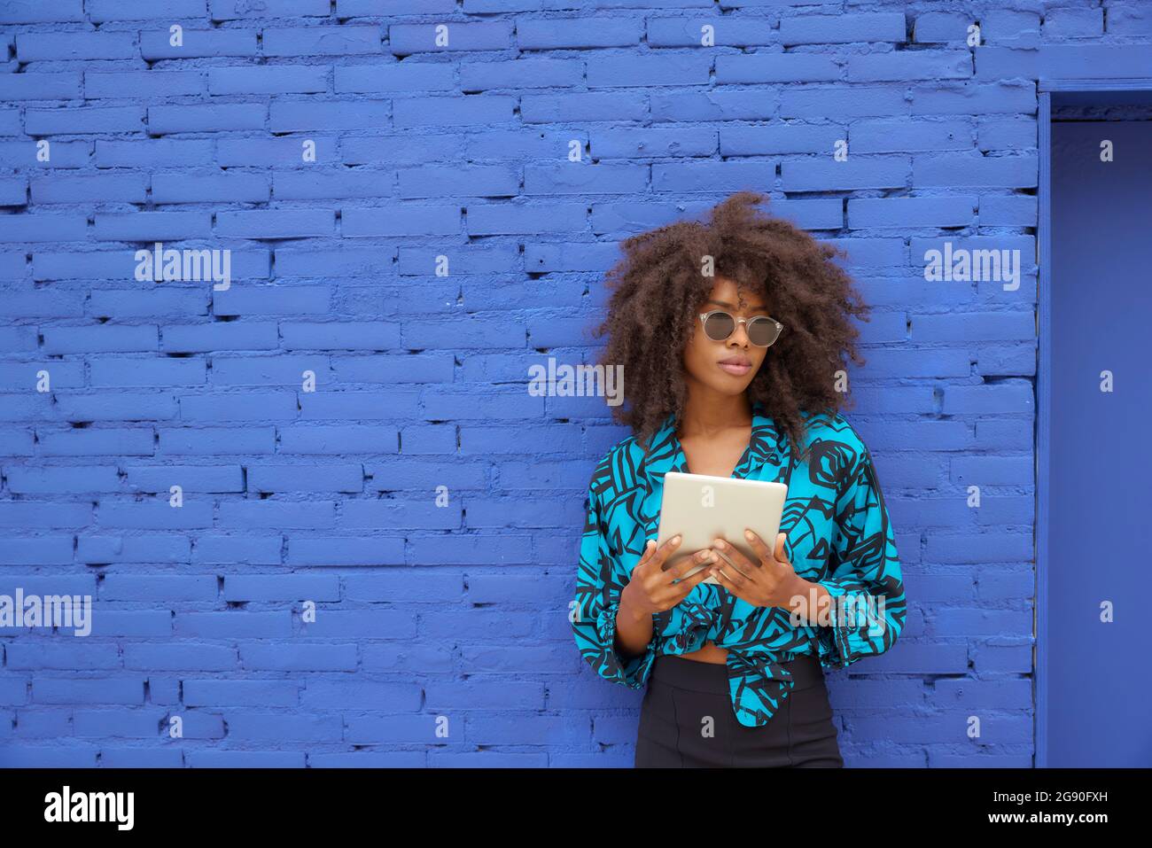 Leaning looking away communication holding sunglasses hi-res stock ...