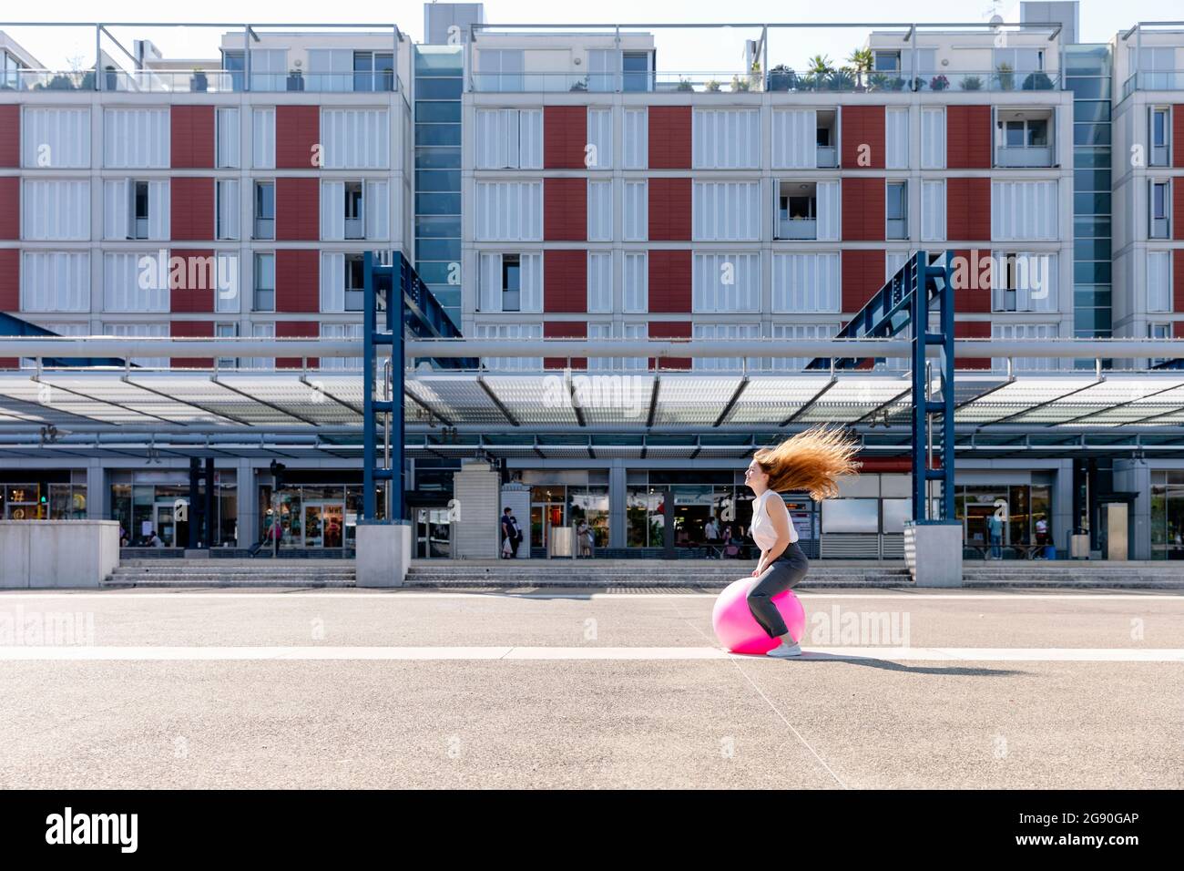 Female professional jumping with bouncy ball during sunny day Stock ...