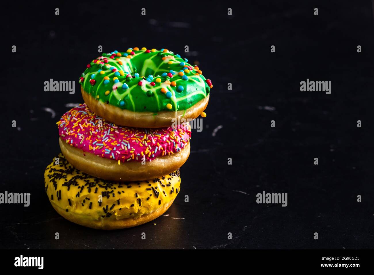 Glazed donuts with sprinkles isolated. Close up of colorful donuts ...