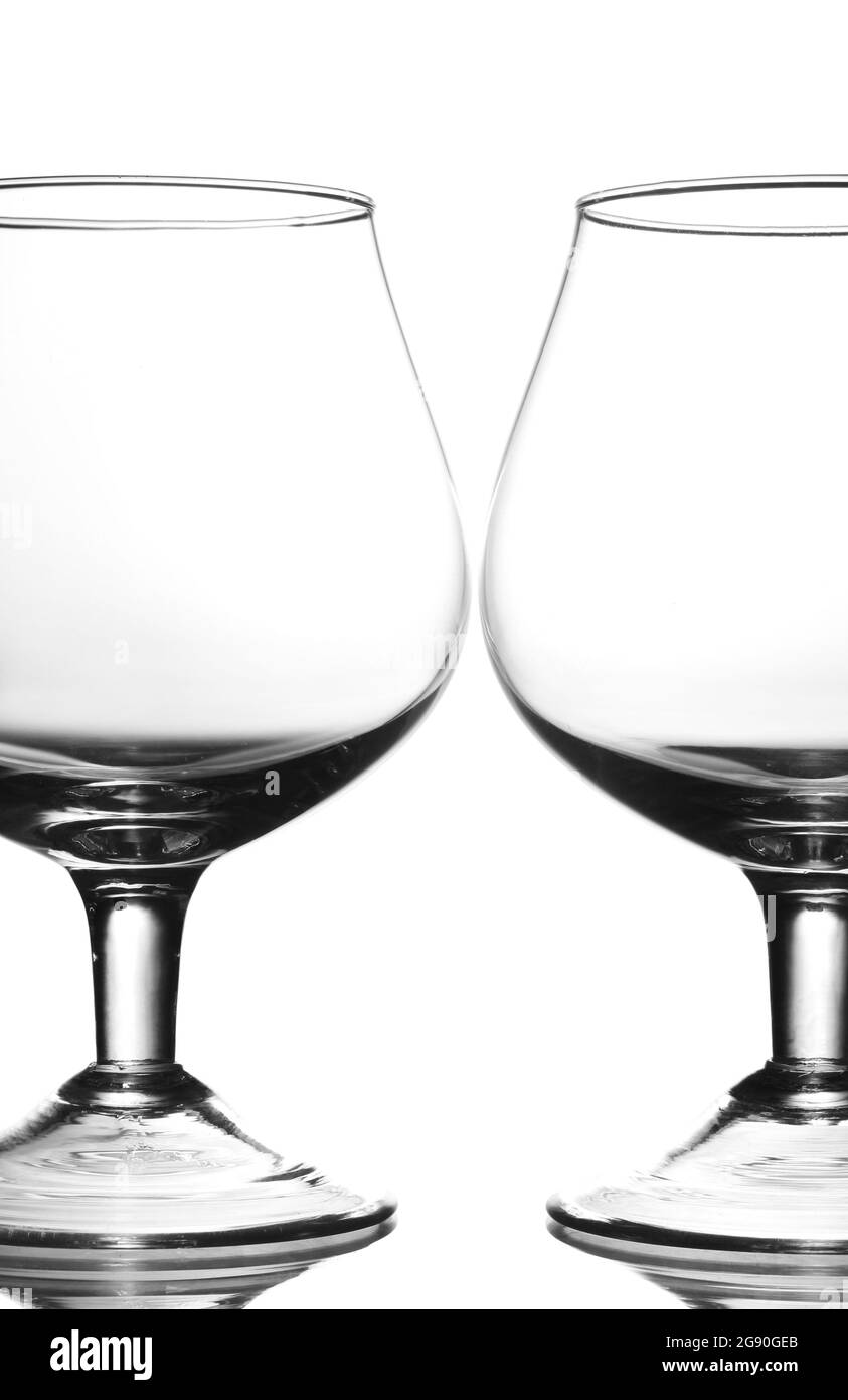 Two empty glasses isolated on white Stock Photo - Alamy