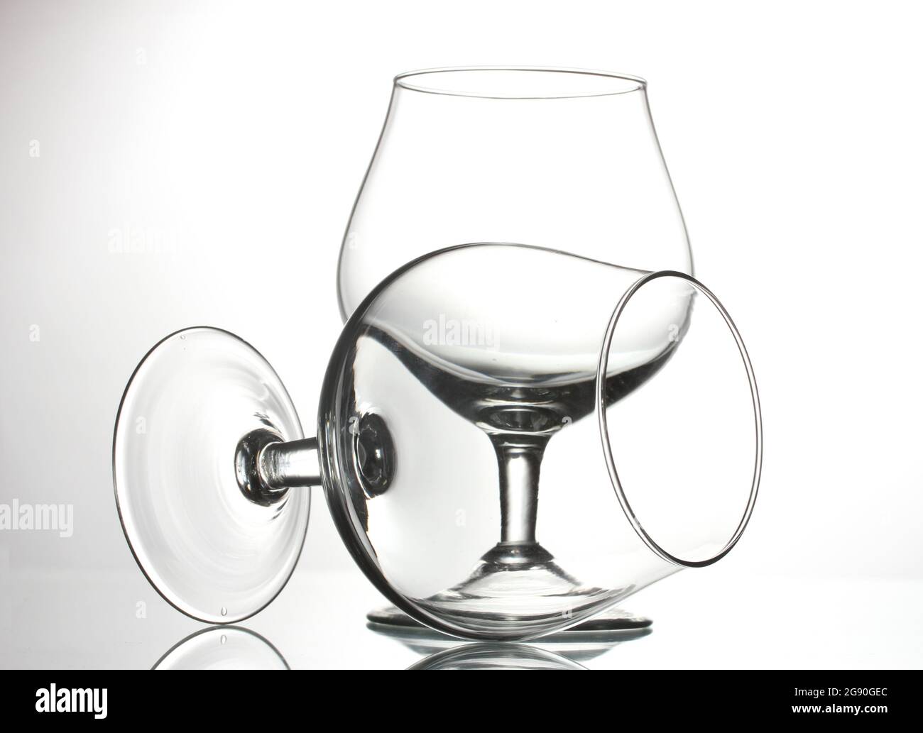 Two empty glasses isolated on white Stock Photo - Alamy