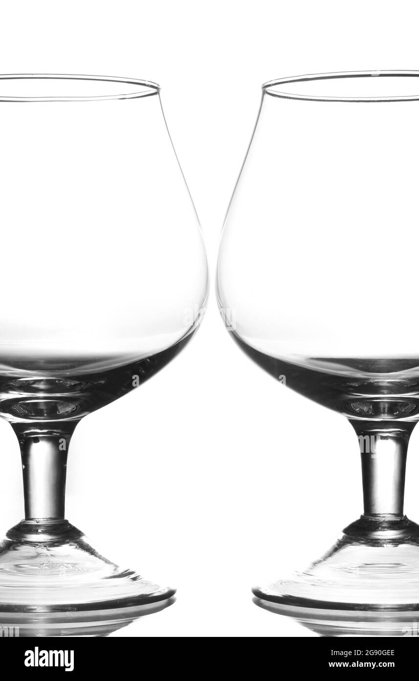 Two empty glasses isolated on white Stock Photo - Alamy