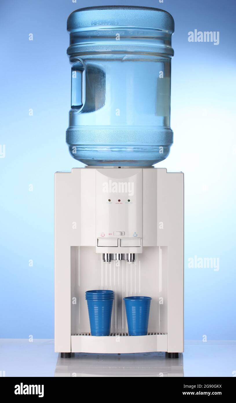 Electric water cooler on blue background Stock Photo - Alamy