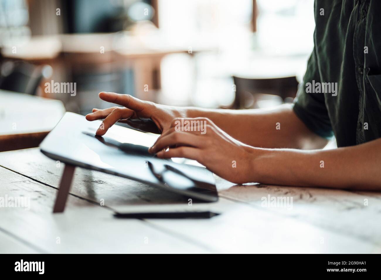 Young businessman using graphic tablet while working at cafe Stock ...