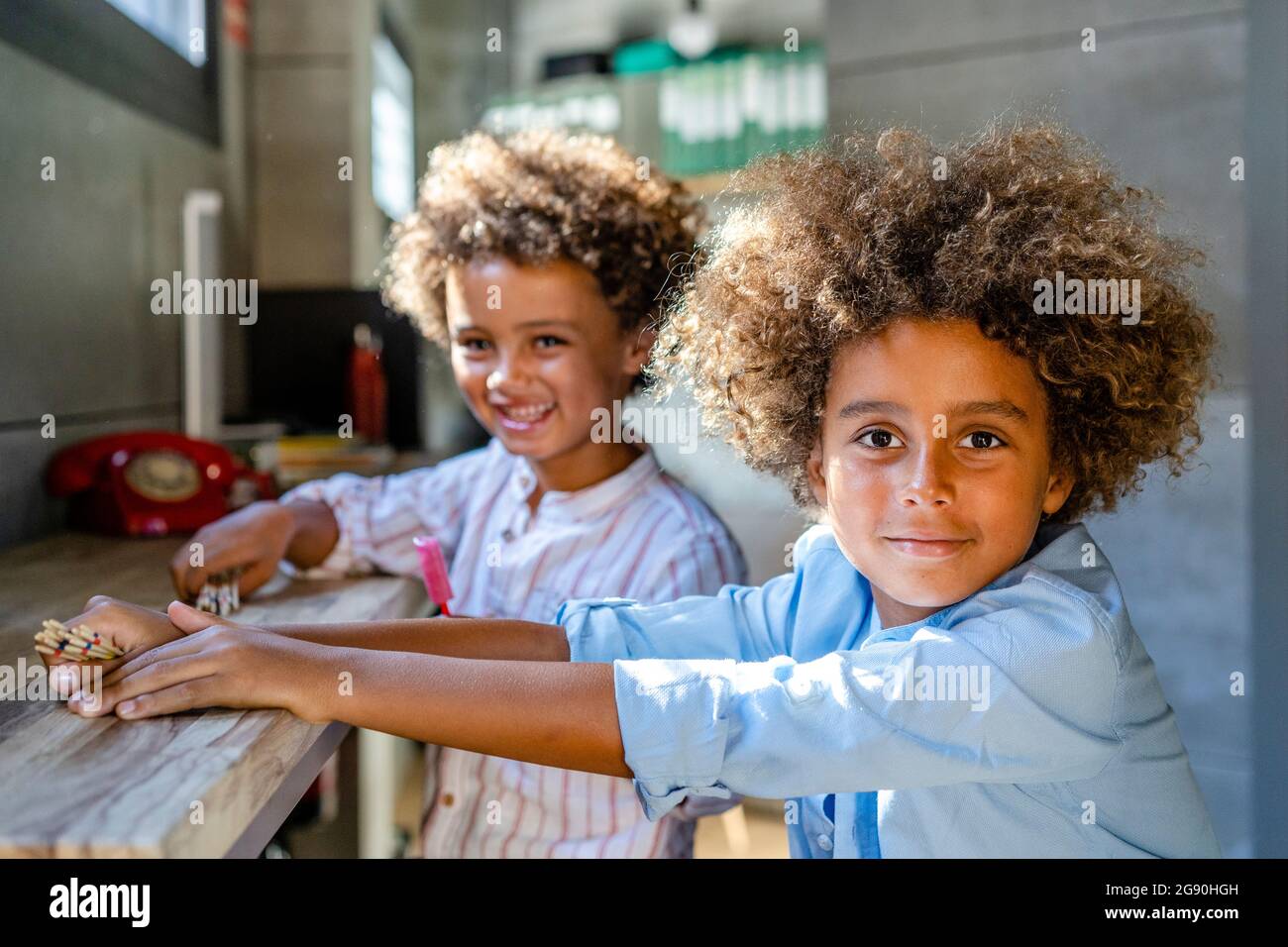 Boys with pick up sticks sitting at table Stock Photo - Alamy