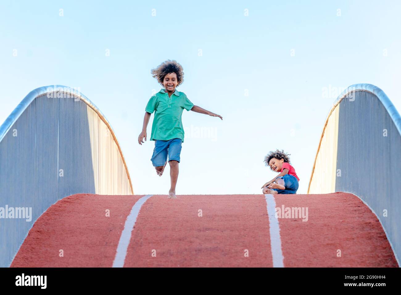 Boy running on bridge hi-res stock photography and images - Alamy