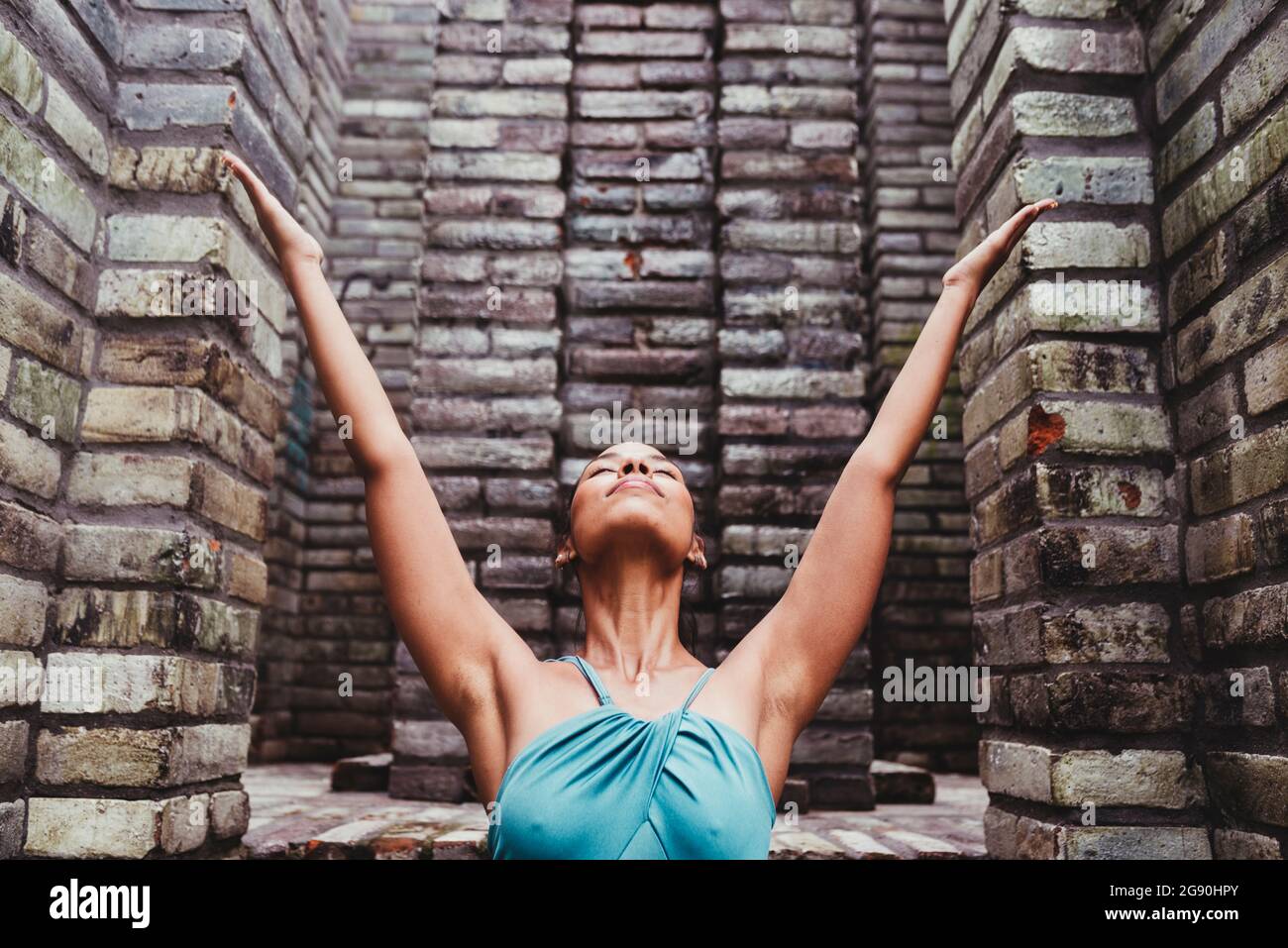 Female dancer meditating with arms raised Stock Photo - Alamy